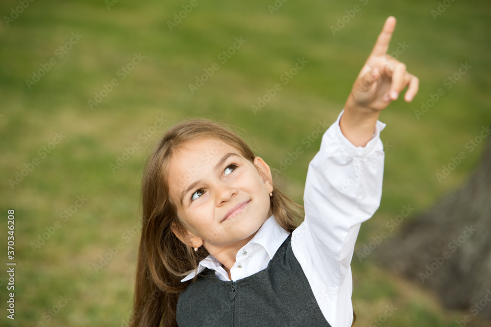 Look over there. Little child point finger up outdoors. Little girl ...