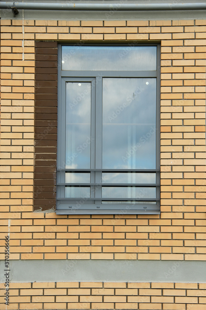 Window on background of brick wall of residential building. Insulated ...