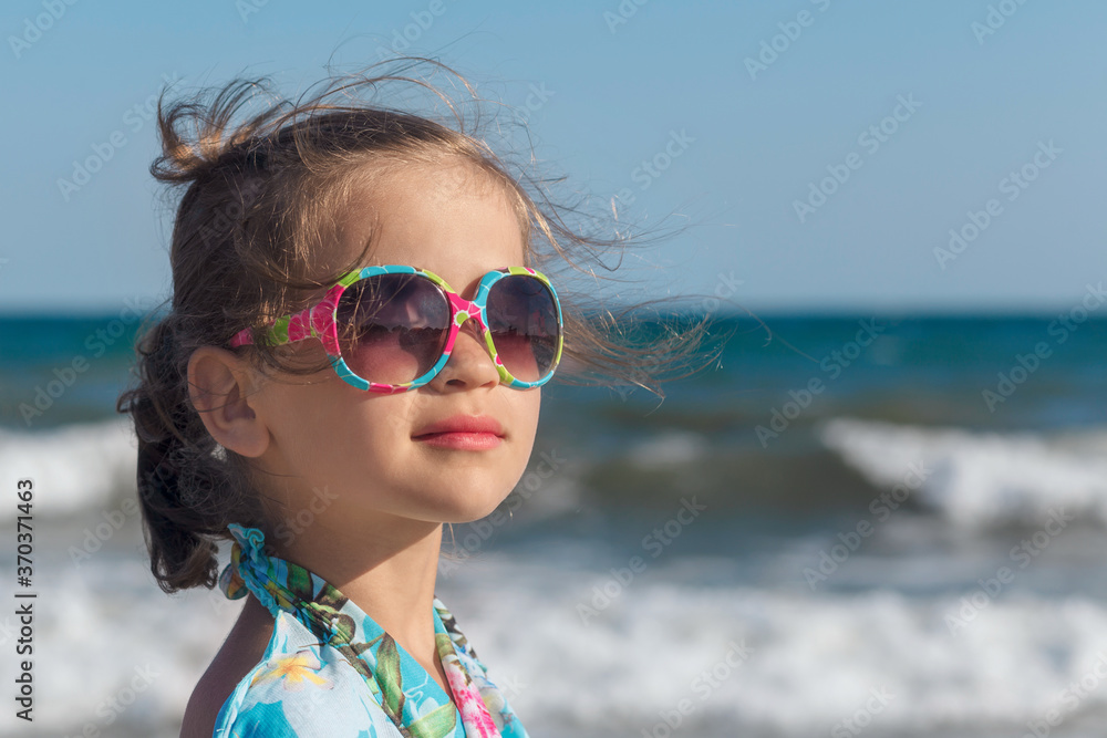 holidays with children near the ocean. The face of a little girl in ...