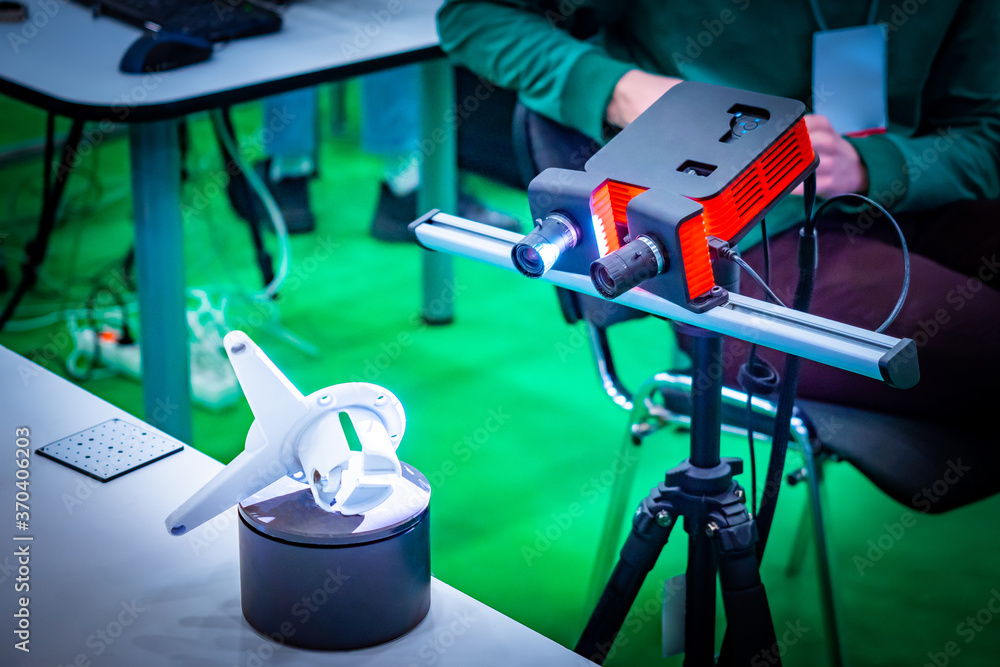 Engineer adjusts the device for 3D Modeling. The device produces a ...