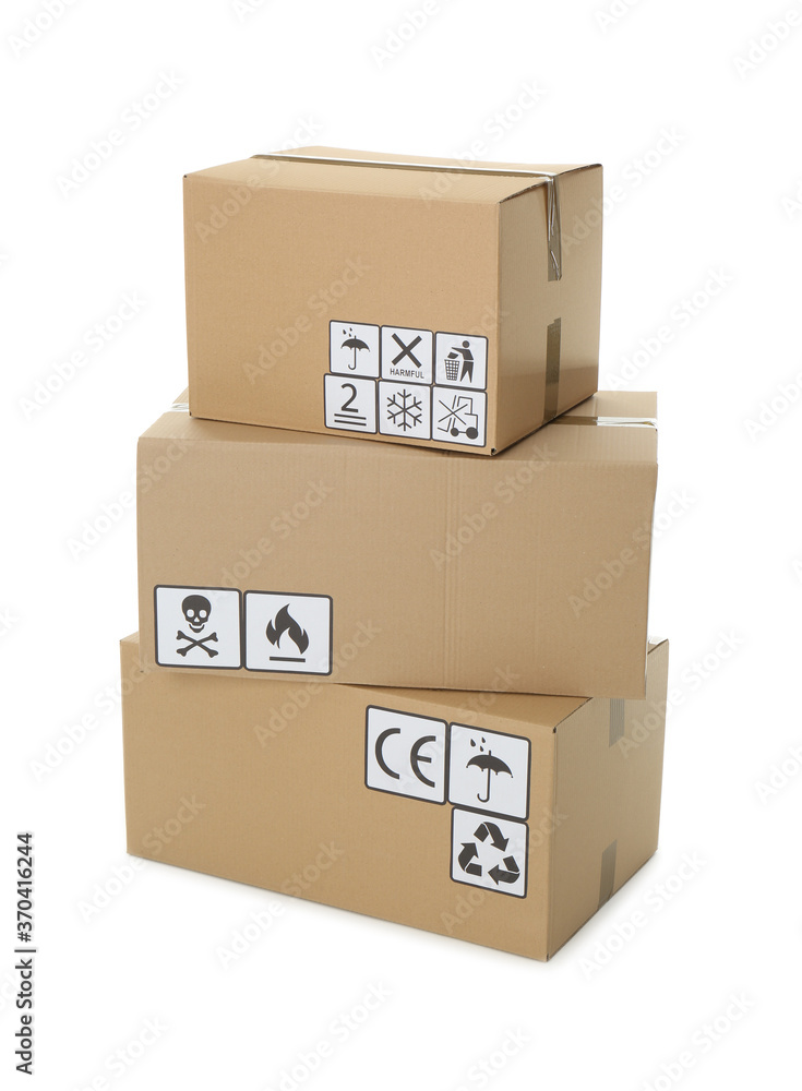 Stack of cardboard boxes with different packaging symbols on white ...