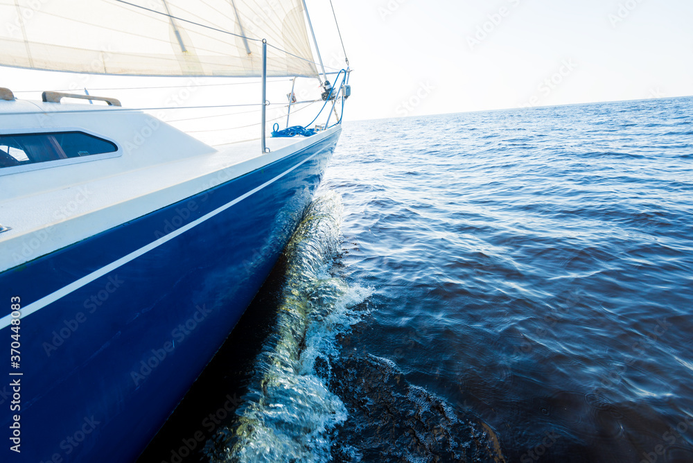 Blue sloop rigged yacht in an open Baltic sea on a sunny summer day ...
