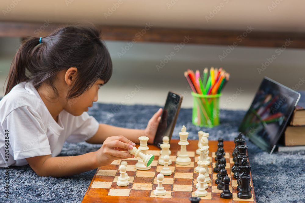 little girl having online chess lesson, e-education, distance learning ...