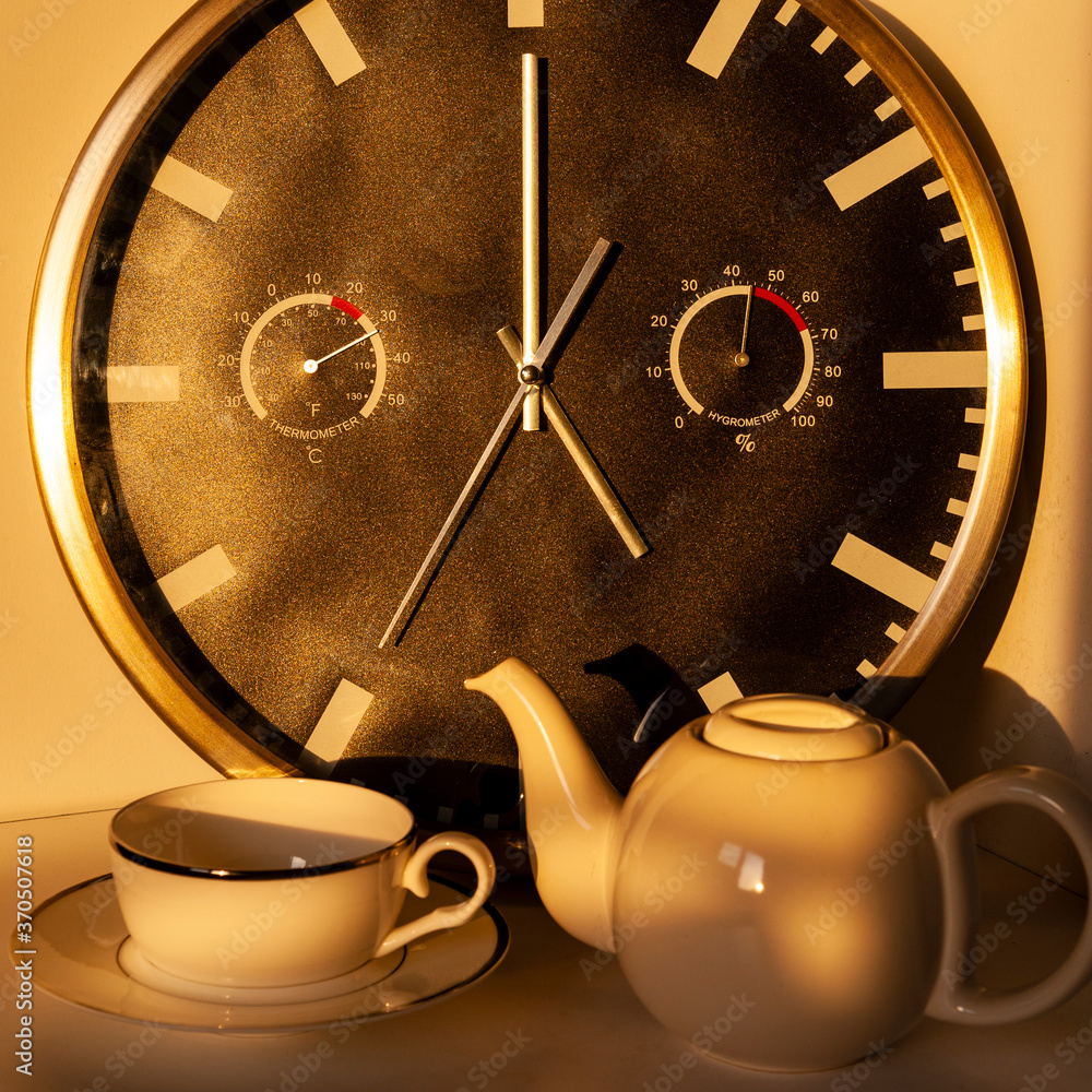 Five o’clock tea with a big wall clock showing five o’clock sharp, a ...