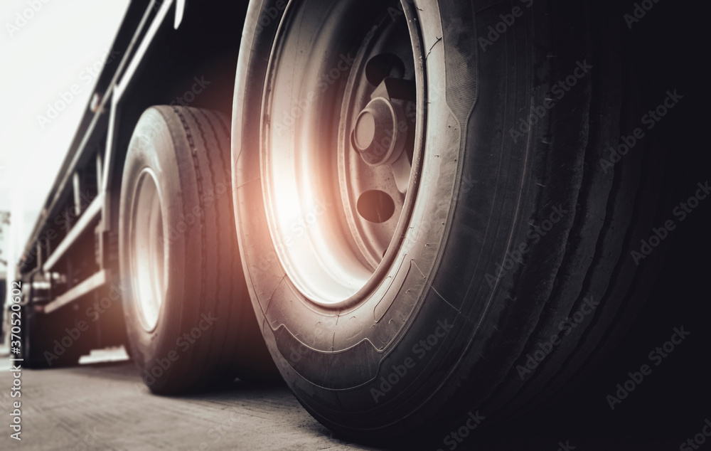 Freight transportation. Close-up large a truck wheels and tires of semi ...