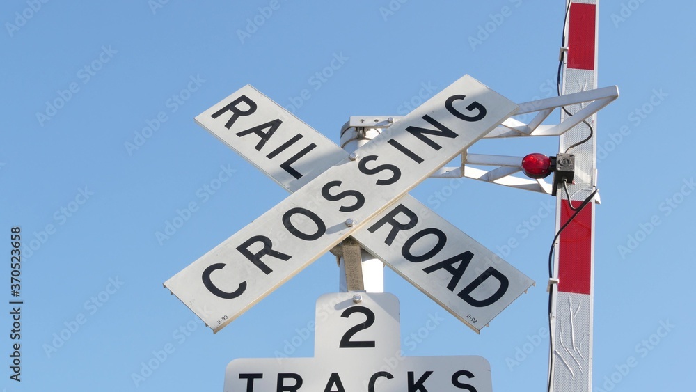 Level crossing warning signal in USA. Crossbuck notice and red traffic ...