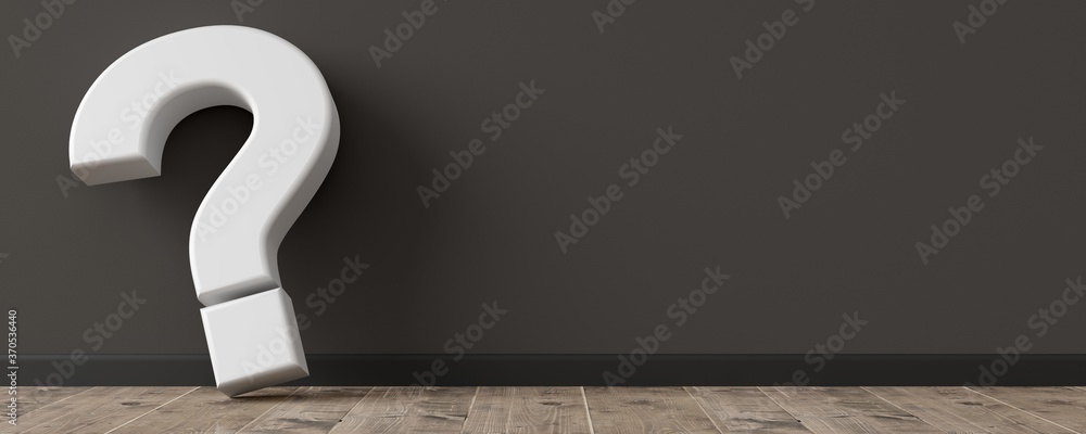 White question mark symbol leaning against dark wall on wooden floor ...