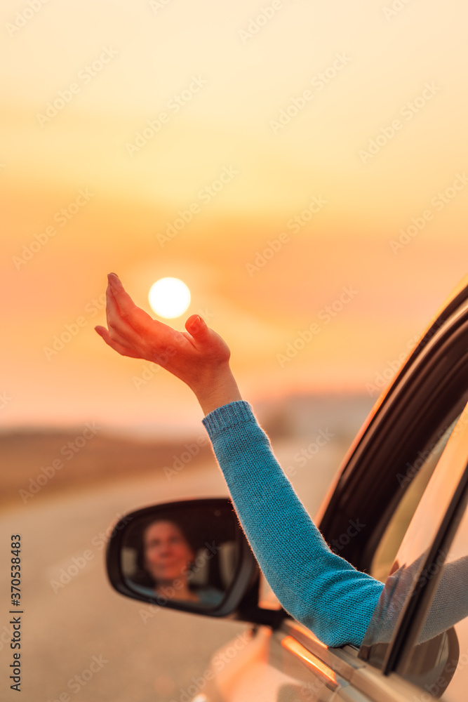 Woman driver putting hand out of car window while driving Stock Photo ...