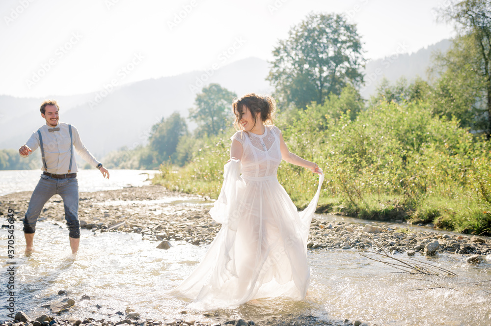 happy, emotional gorgeous bride and stylish groom having fun, splashed ...