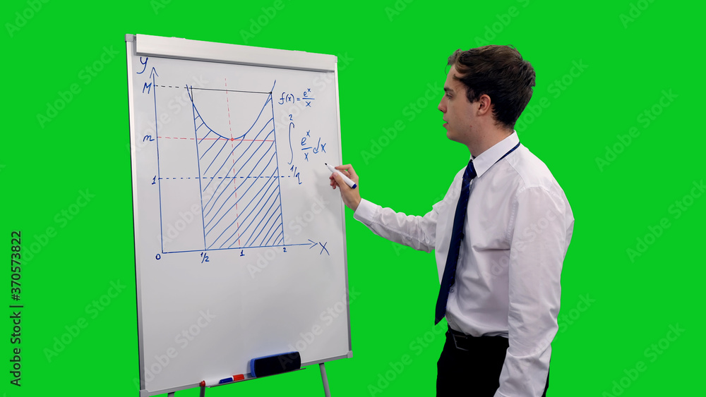 Handsome student writing and explaining math formula on board against ...