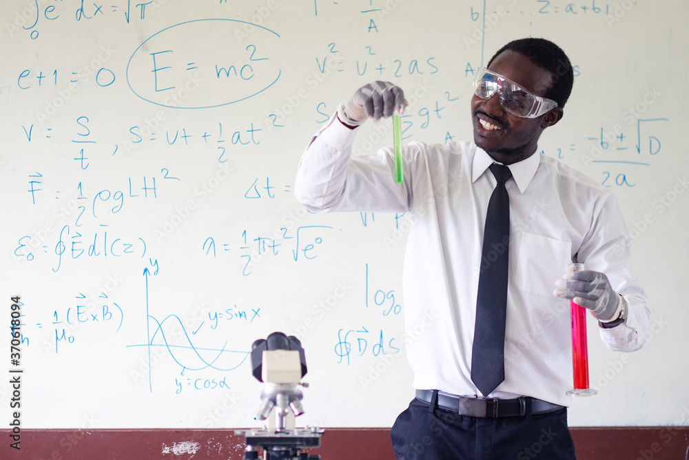 Science african teacher standing in front of blackboard teaching ...