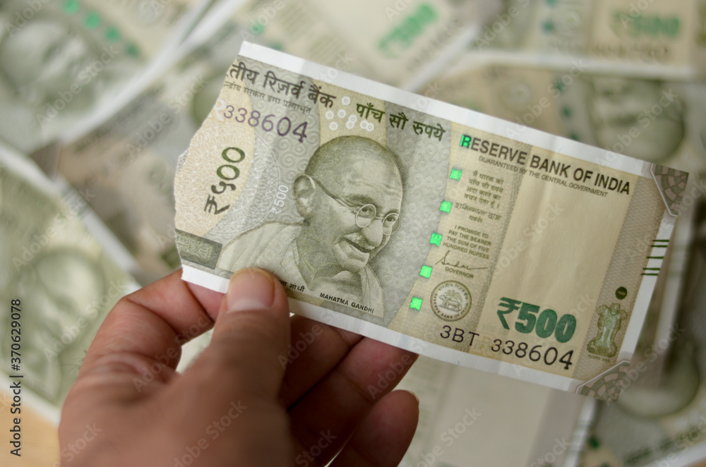 A woman hand holding a torn new Rs 500 Rupees Indian Currency notes ...