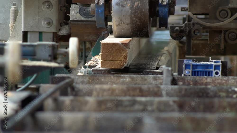 Sawing machine at wood production factory. Timber material processing ...