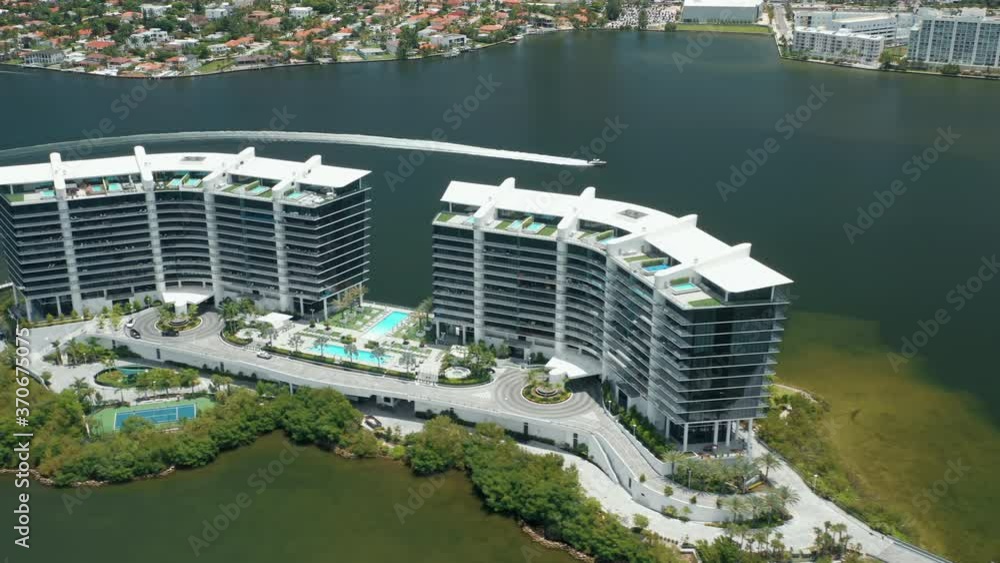 Yacht is sailing in the bay. Modern architecture residential complex ...