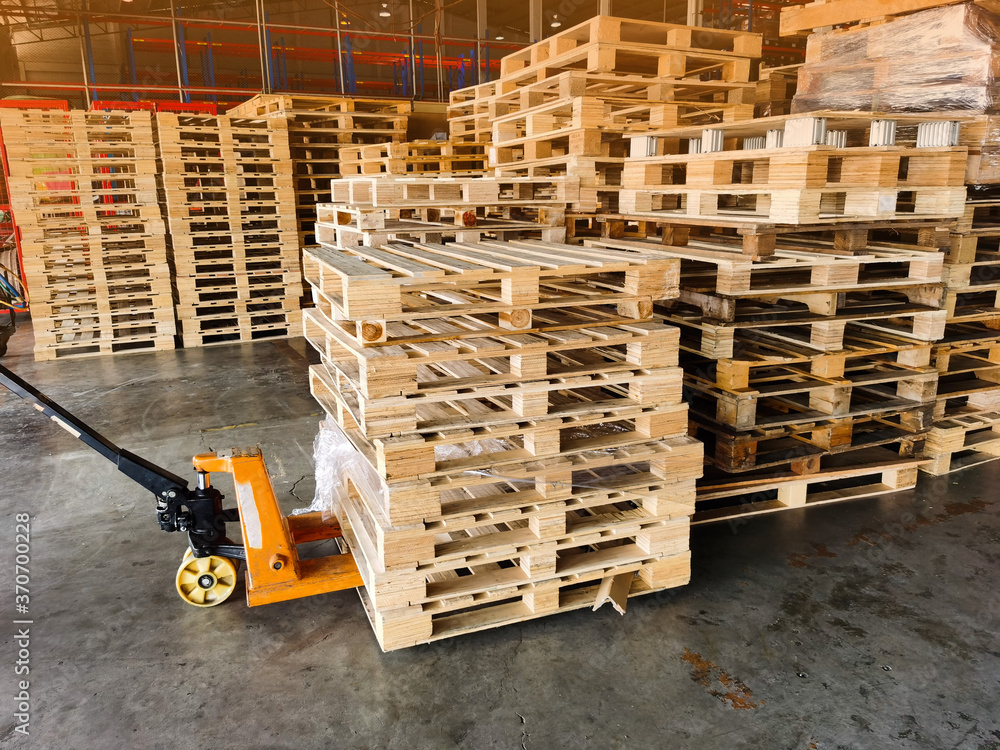Worker driving forklift to loading and unloading wooden pallets from ...