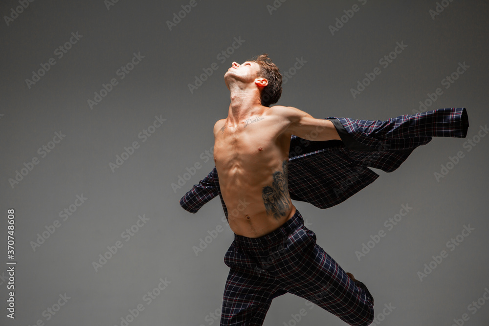Cool young guy dancer in suit dancing in studio. Dance school poster ...