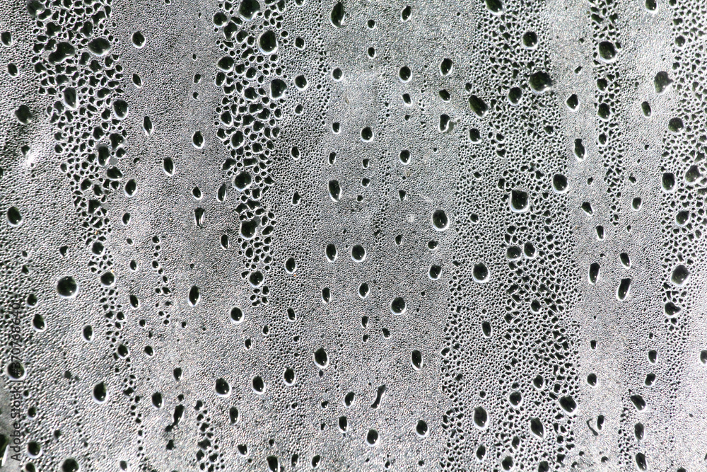 Wet transparent polyethylene film with droplets of water after rain ...