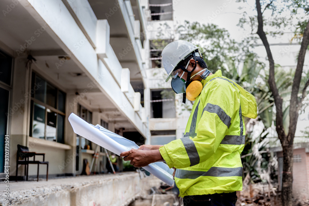 Civil Engineer People wearing face mask and safety helmet while looking ...