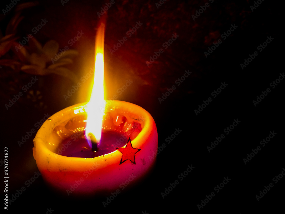 Lightening candle with a star on its body for decoration as a symbol of ...