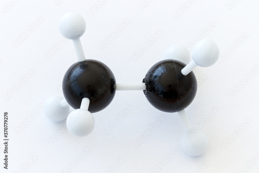Plastic ball-and-stick model of an ethane molecule (C2H6) on a white ...