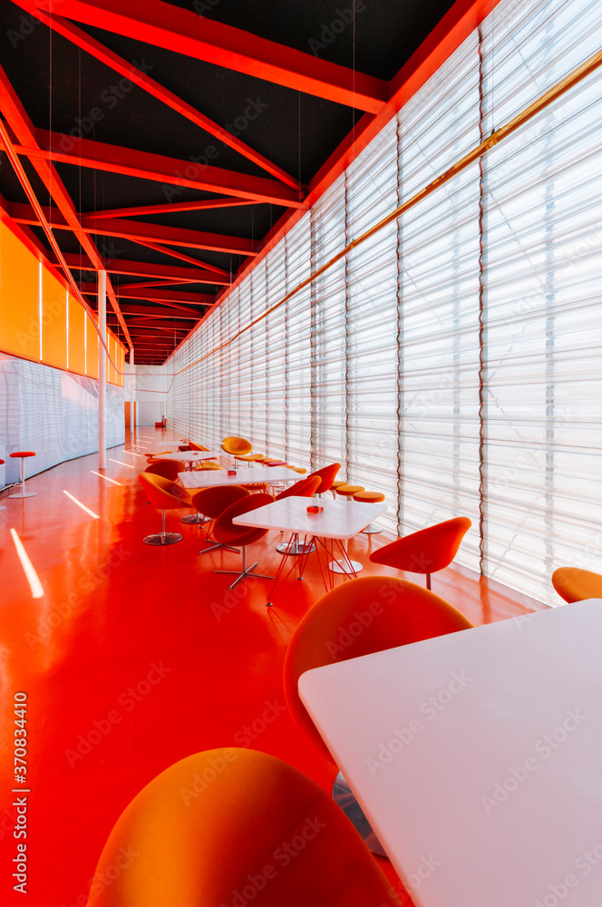 Interior of vivid cafe with contemporary tables and chairs placed on ...