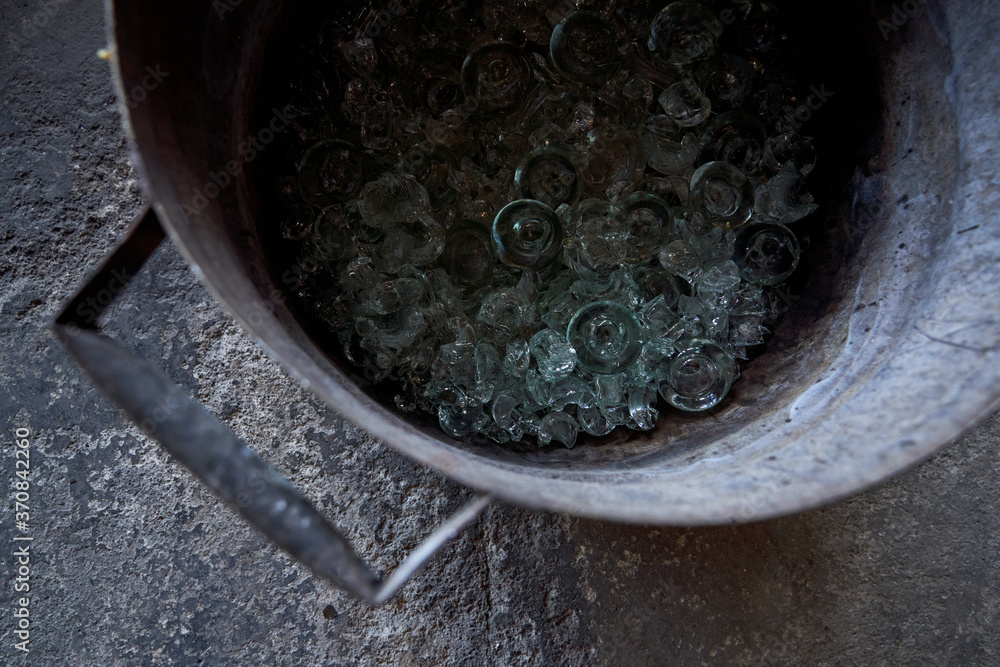 Top view of big metal barrel filled with assorted pieces of broken ...