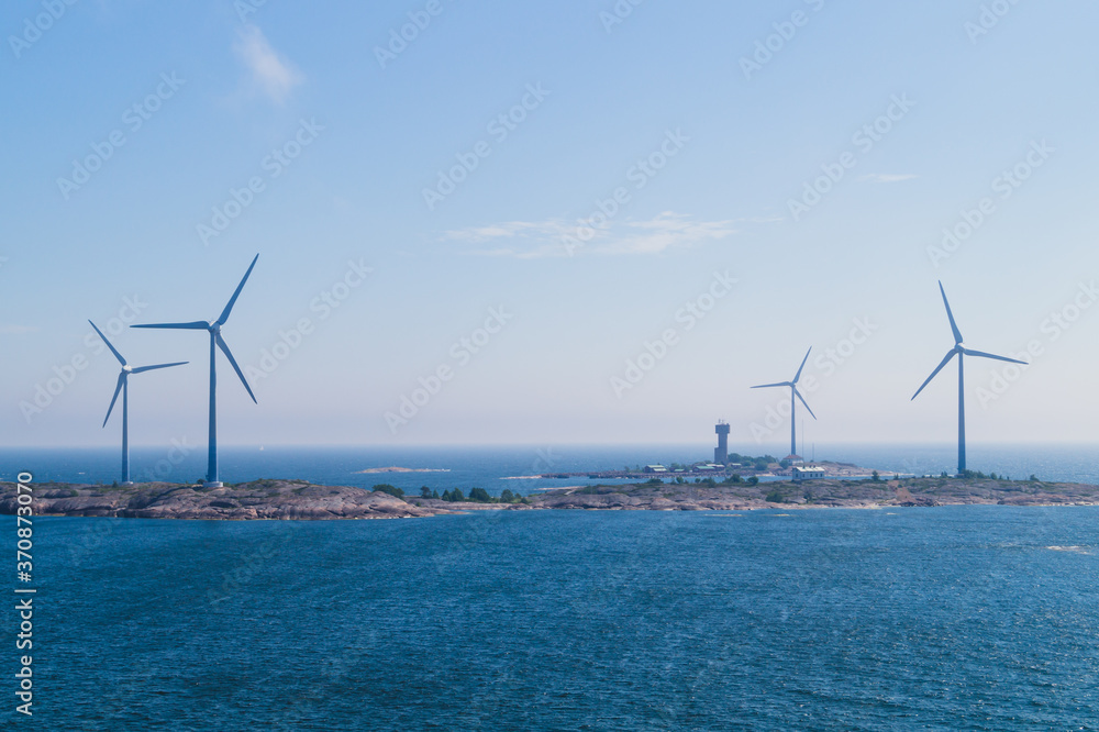 Windmill on an island in the sea. wind generator for generating ...