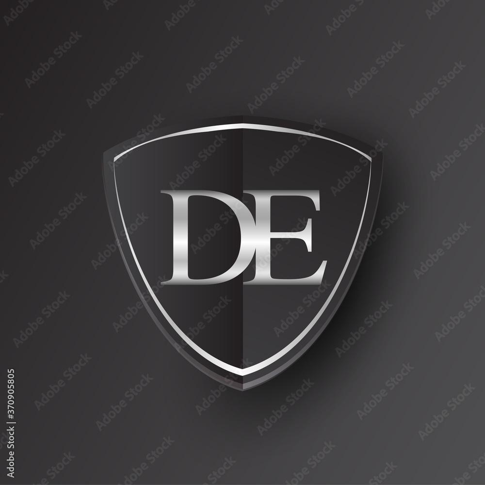 Initial logo letter DE with shield Icon silver color isolated on black ...