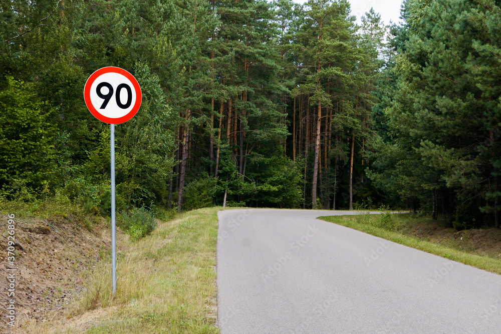 Speed Limit Sign With Trees Behind Maximum Ninety Kilometers Per Hour