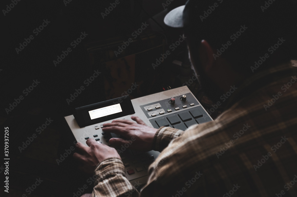 A hip hop composer, beatmaker creates beats on a digital production ...
