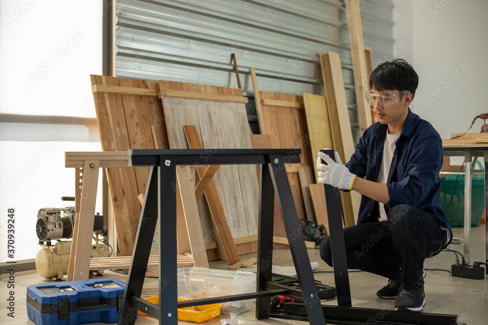 Asian man Carpenter working with technical drawing or blueprint ...
