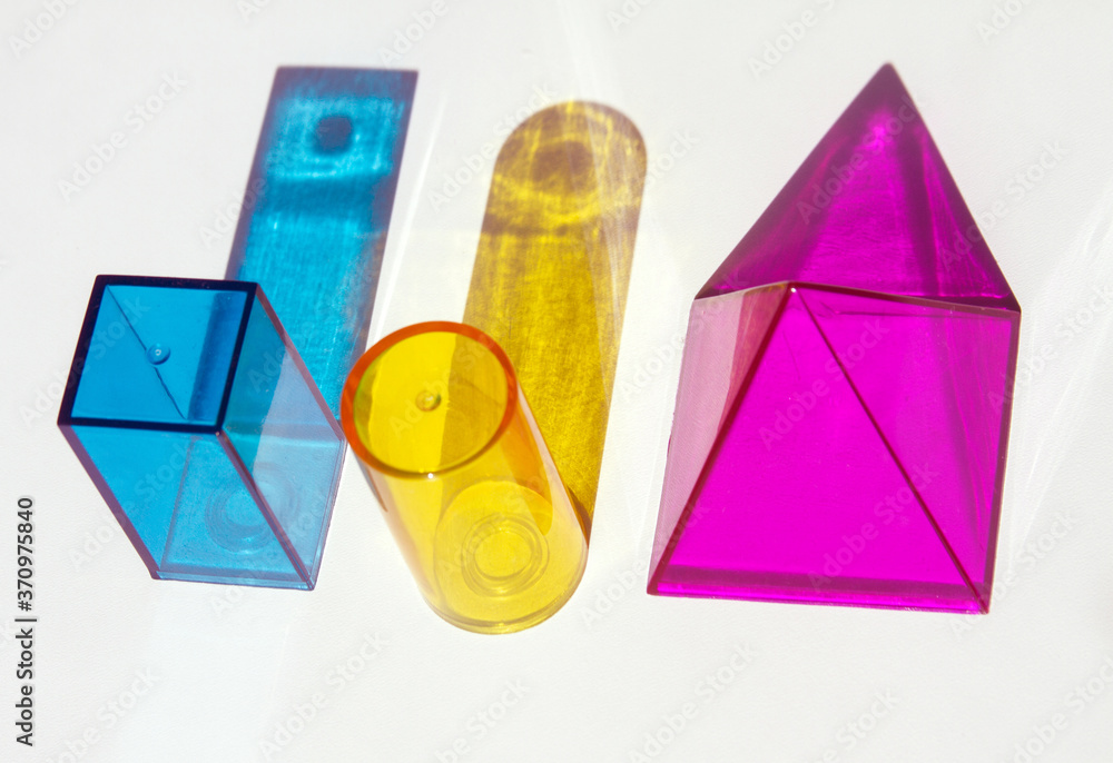 Transparent multicolored geometric shapes - prism, cylinder and ...