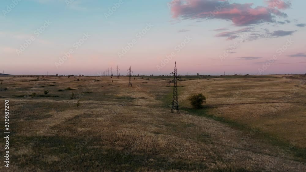 Drone aerial shot of a big field and many transmission towers at the ...