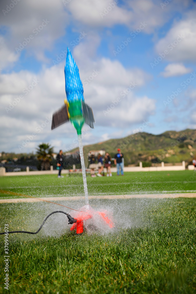 Water bottle rocket with polka dots heavily blurred from being launched ...