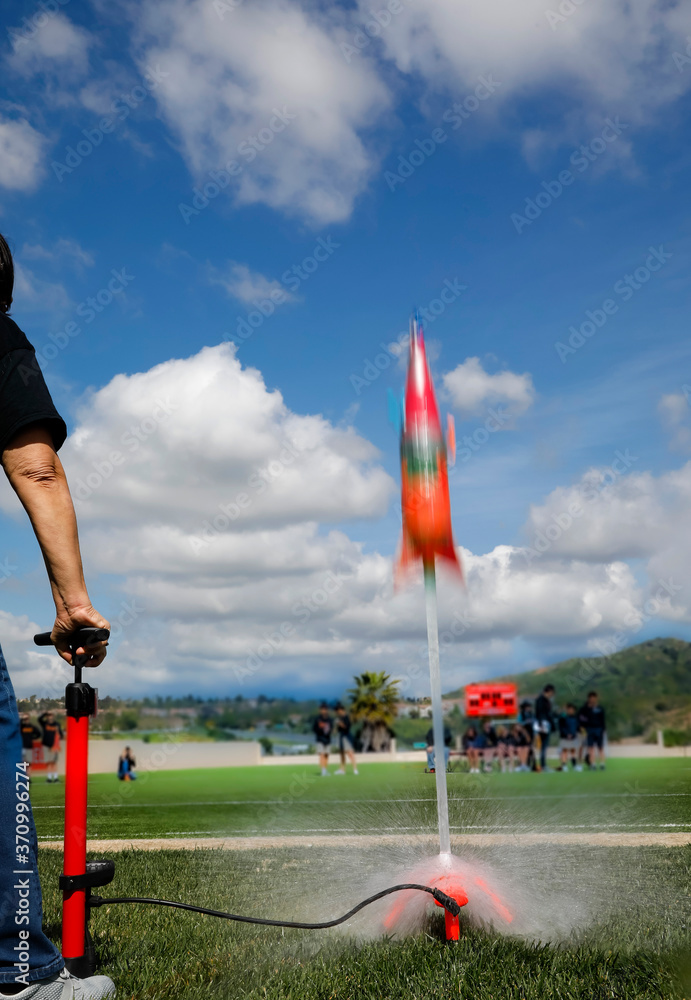 Image of homemade water bottle rocket launching with student’s hand on ...