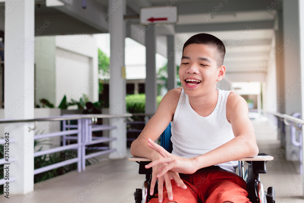 Asian special child on wheelchair and wood trays for activities with ...