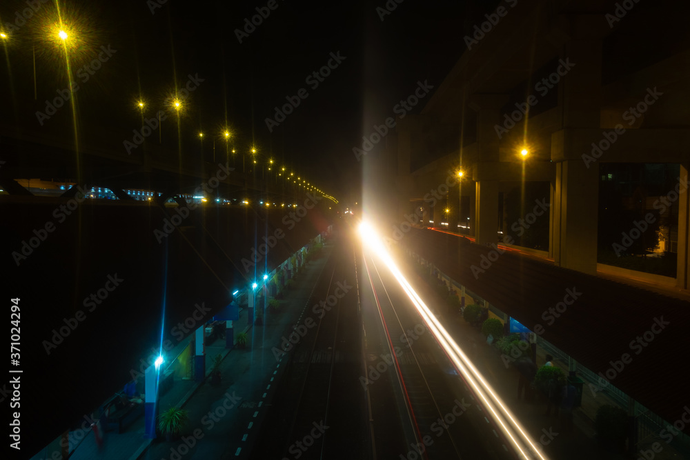Long exposure Light from the train runs on the road train,Before ...
