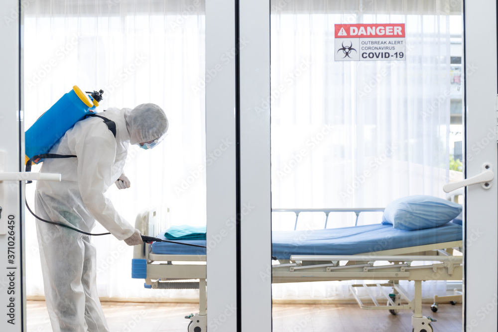 Staff protective suit PPE and mask.Cleaning and Disinfection in a room ...