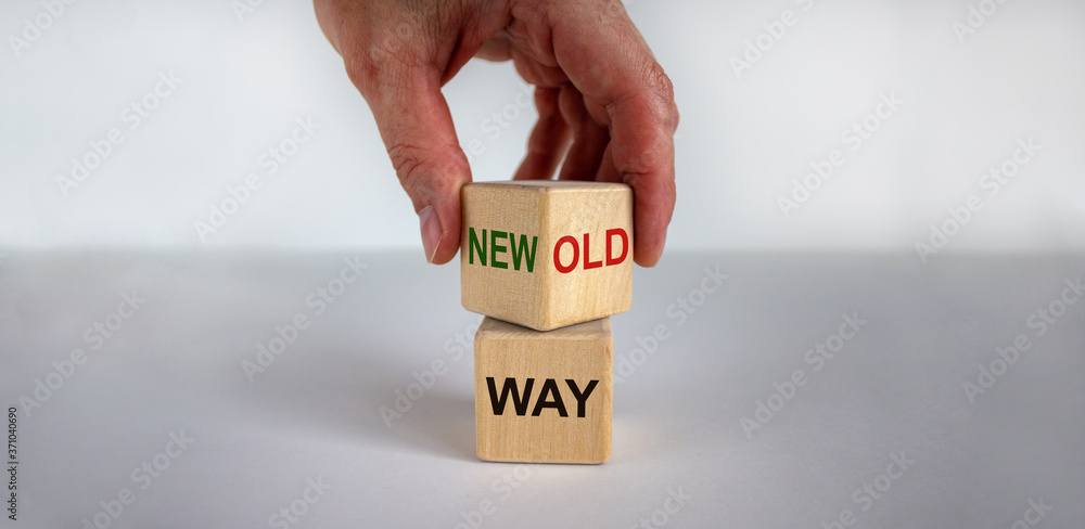 Male hand flips wood cube with 'new way' or 'old way' words on ...
