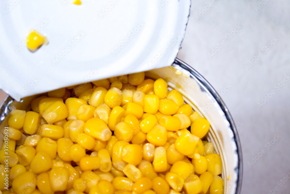 Canned sweet corn in opened metallic jar isolated on white background ...