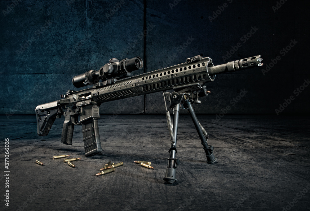AR 15 displayed on a bipod with a magazine inserted and shell casings ...