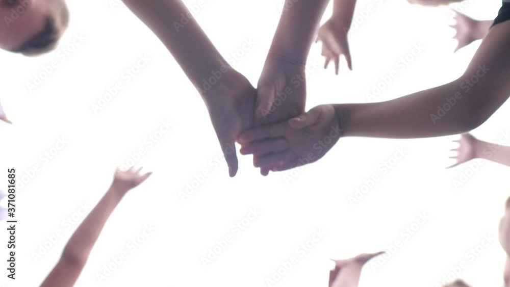 Kids team building. A group of happy children holding hands together ...