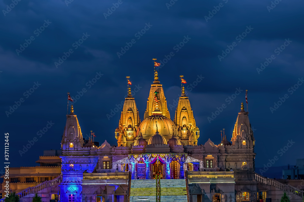 Lighted image of Shree Swaminarayan temple with monsoon clouds ...