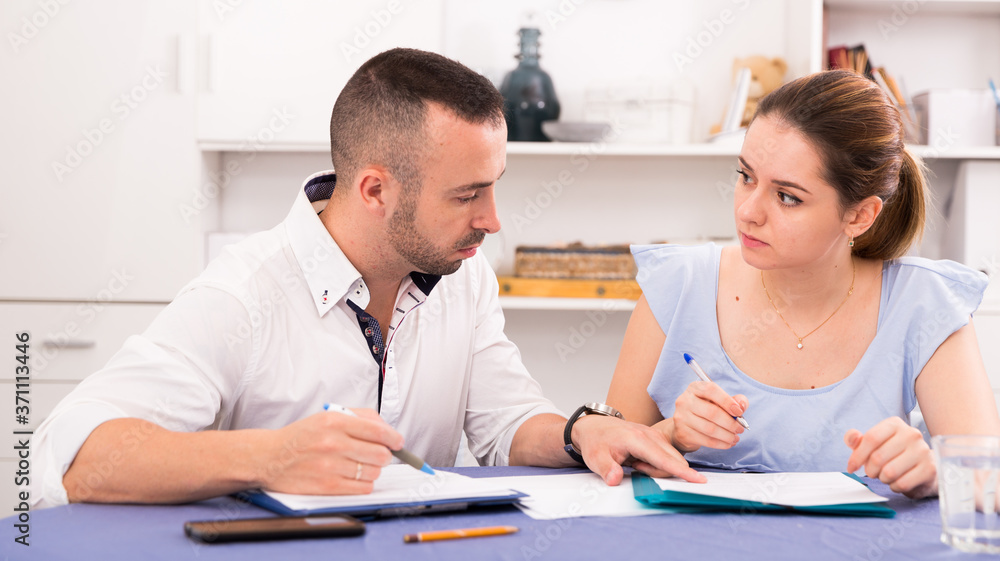 Man with his wife are sad about loans at home. Stock Photo | Adobe Stock