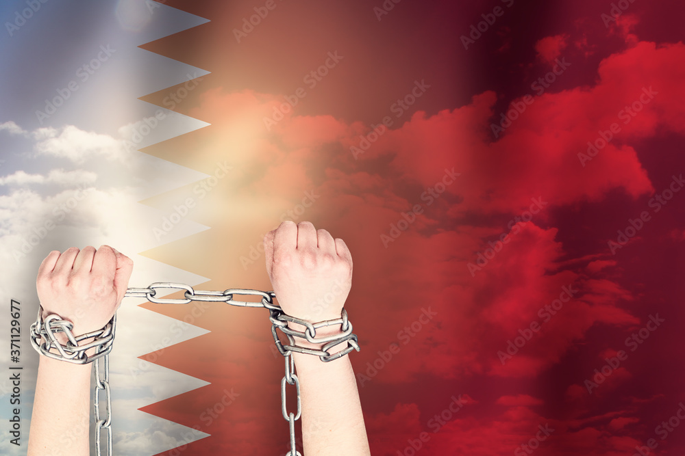 Two hands shackled a metal chain on the background of Bahrain flag ...