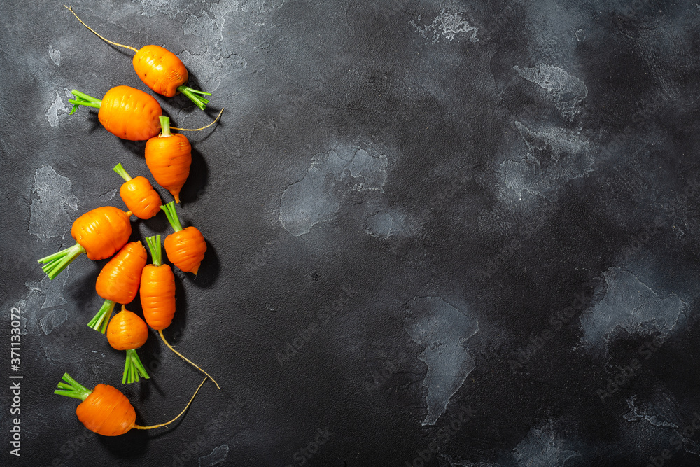 Short Rondo carrots on dark textured background with copy space, top ...