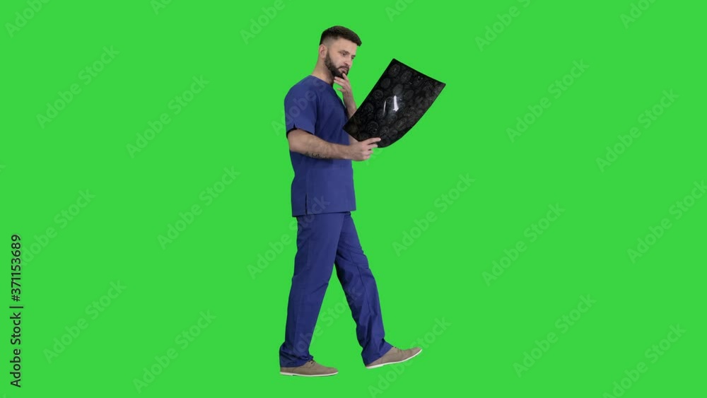 Surgeon studying mri brain scan while walking on a Green Screen, Chroma ...