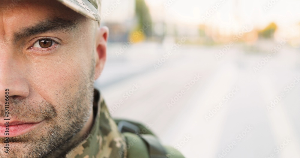 Portrait of Caucasian handsome young man soldier in cap with backpack ...