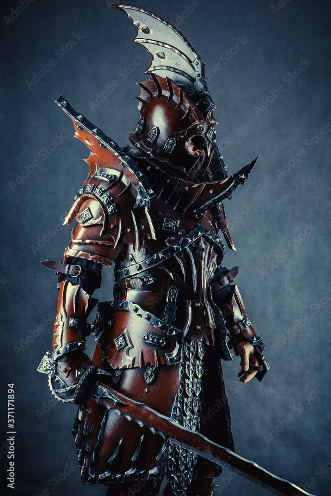 Powerful knight in the armor with the sword. Dark background. Stock ...
