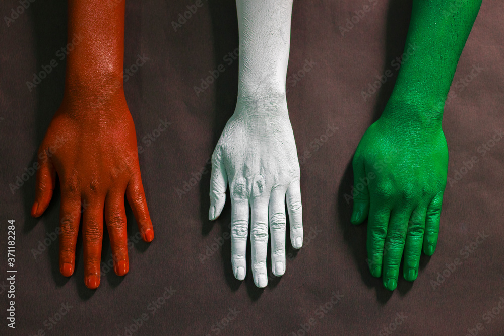 three hands are painted with three colors,saffron,white and green to ...